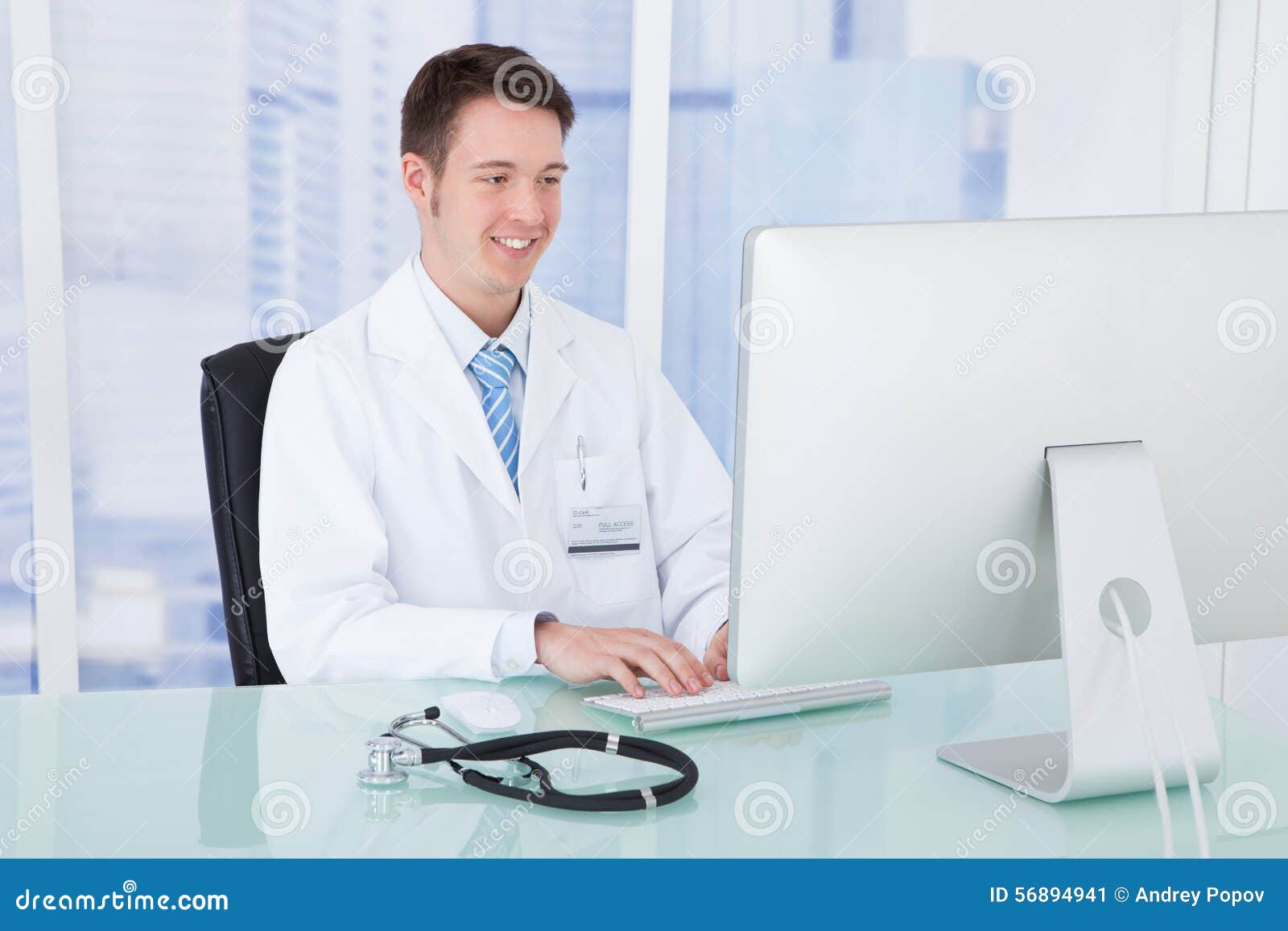 Doctor Using Computer at Desk in Clinic Stock Image - Image of person ...