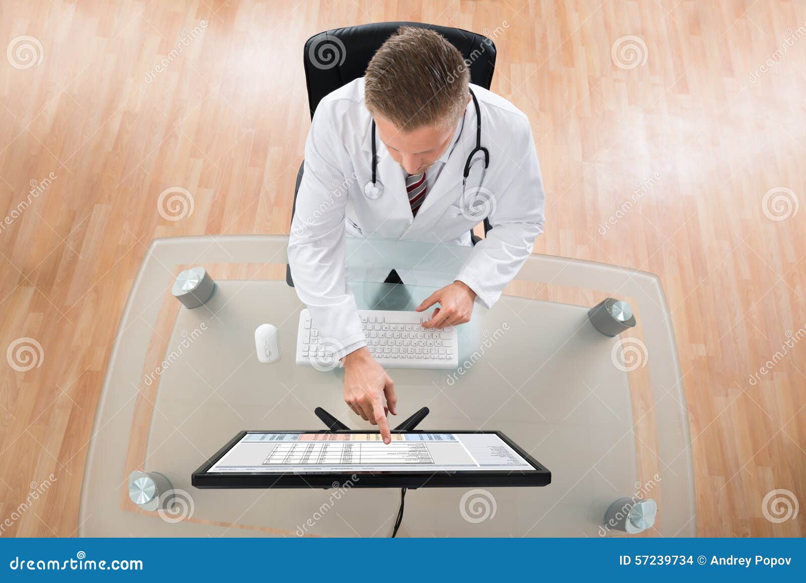 Doctor Using Computer at Desk Stock Photo - Image of gesture, floor ...