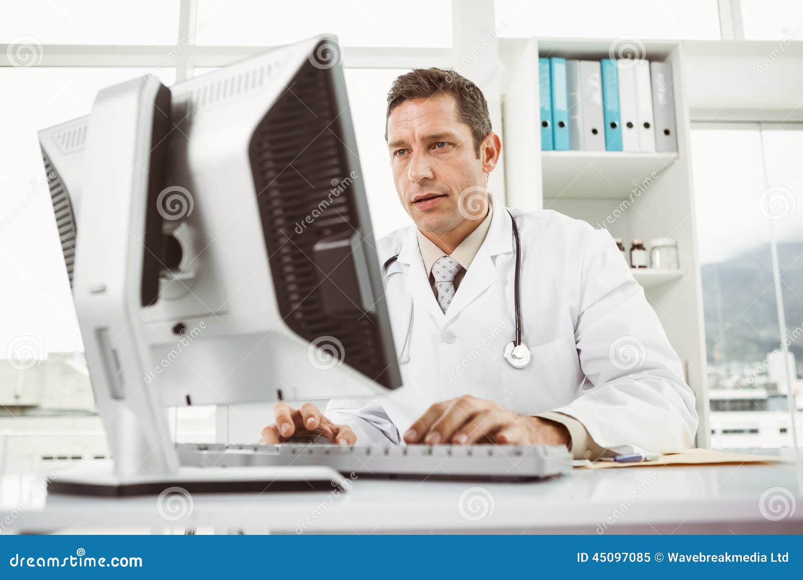 Doctor Using Computer at Medical Office Stock Image - Image of front ... Doctor Using Computer at Medical Office Stock Image - Image of front ...