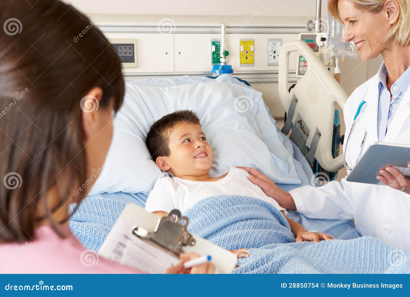 Doctor Using Digital Notepad Whilst Visiting Child Patient Stock Photo ...