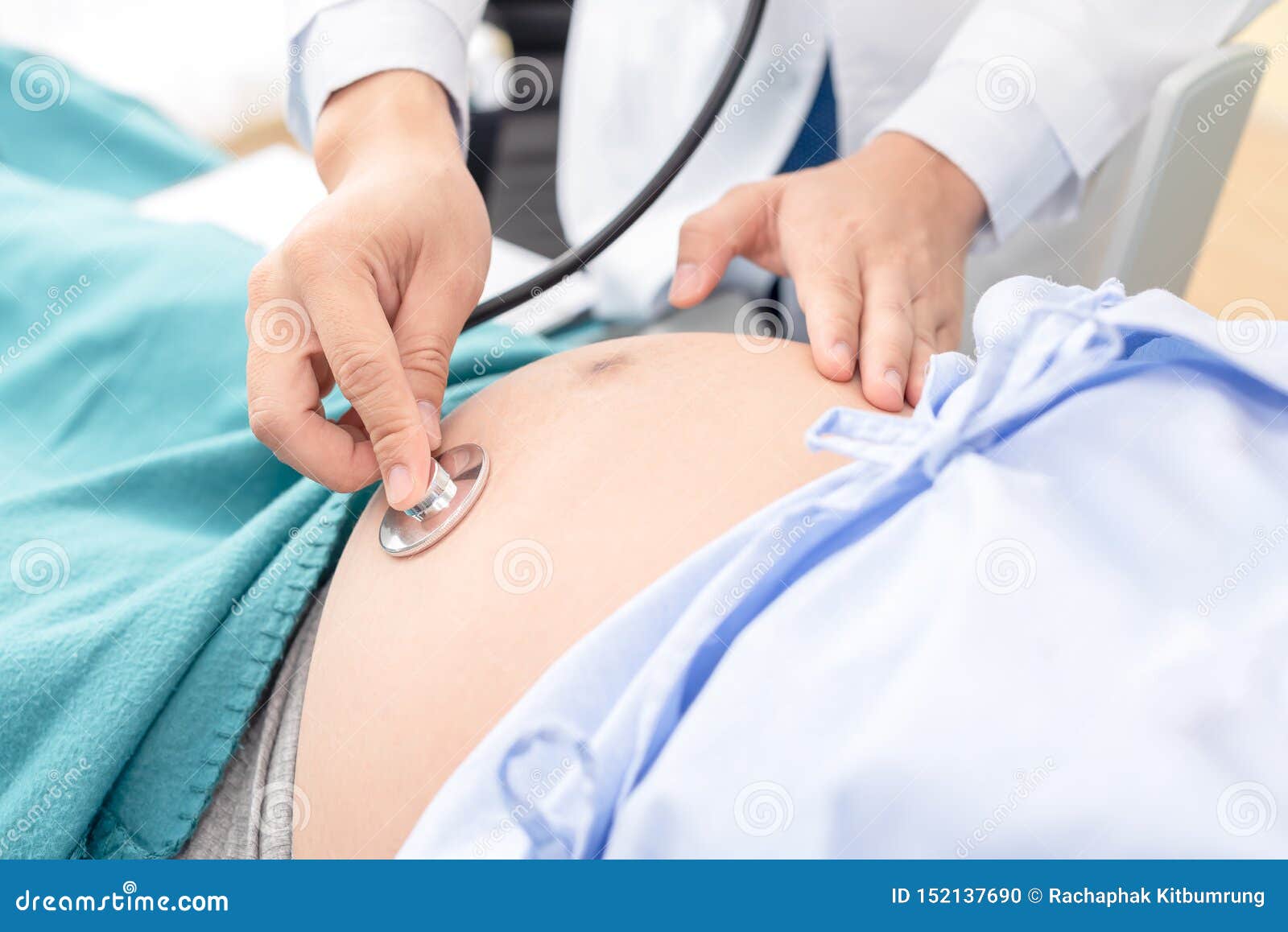 Doctor Using Hands And Stethoscope Listening To Patient Pregnant Tummy
