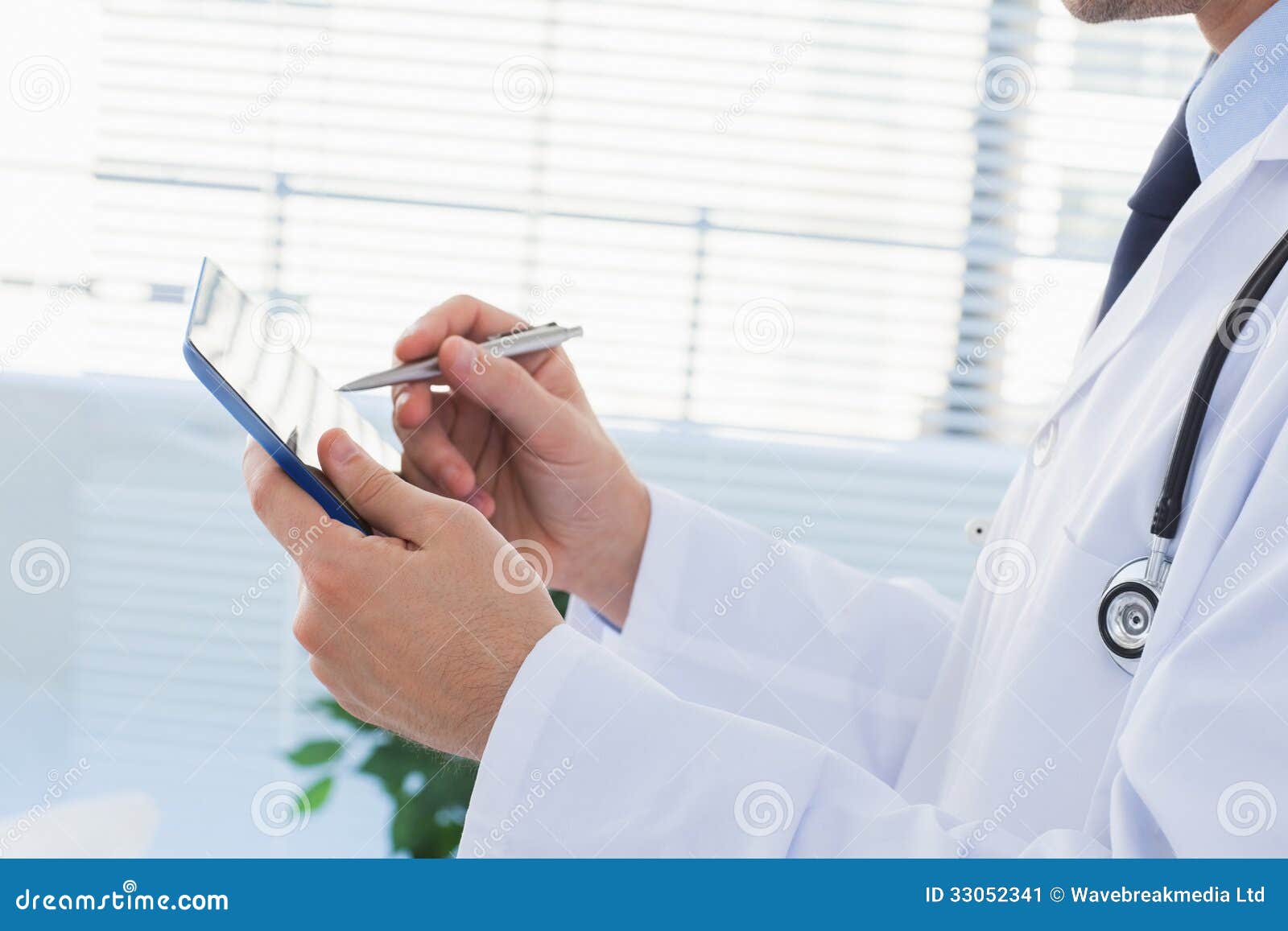 Doctor using his tablet pc stock image. Image of professional - 33052341