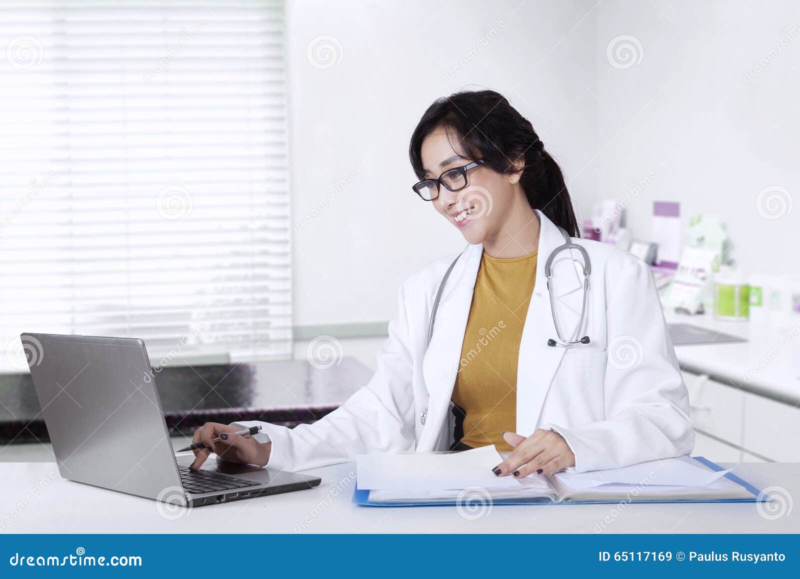 Doctor Using Laptop on Desk in the Clinic Stock Image - Image of ...
