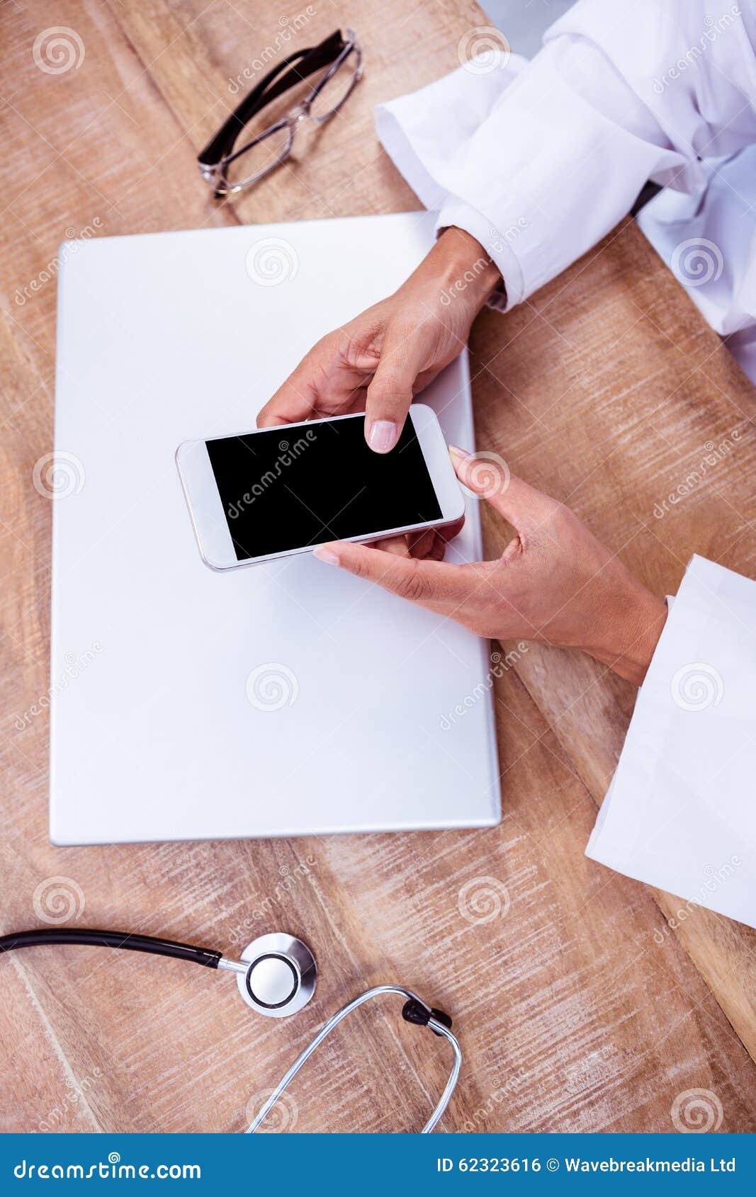 Doctor Using Smartphone on Wooden Desk Stock Photo - Image of coat ...