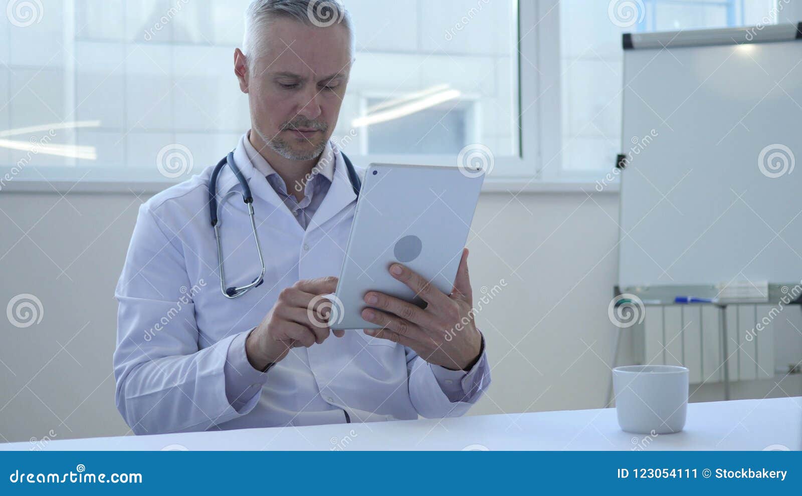 Doctor Using Tablet for Browsing Internet Stock Image - Image of indoor ...