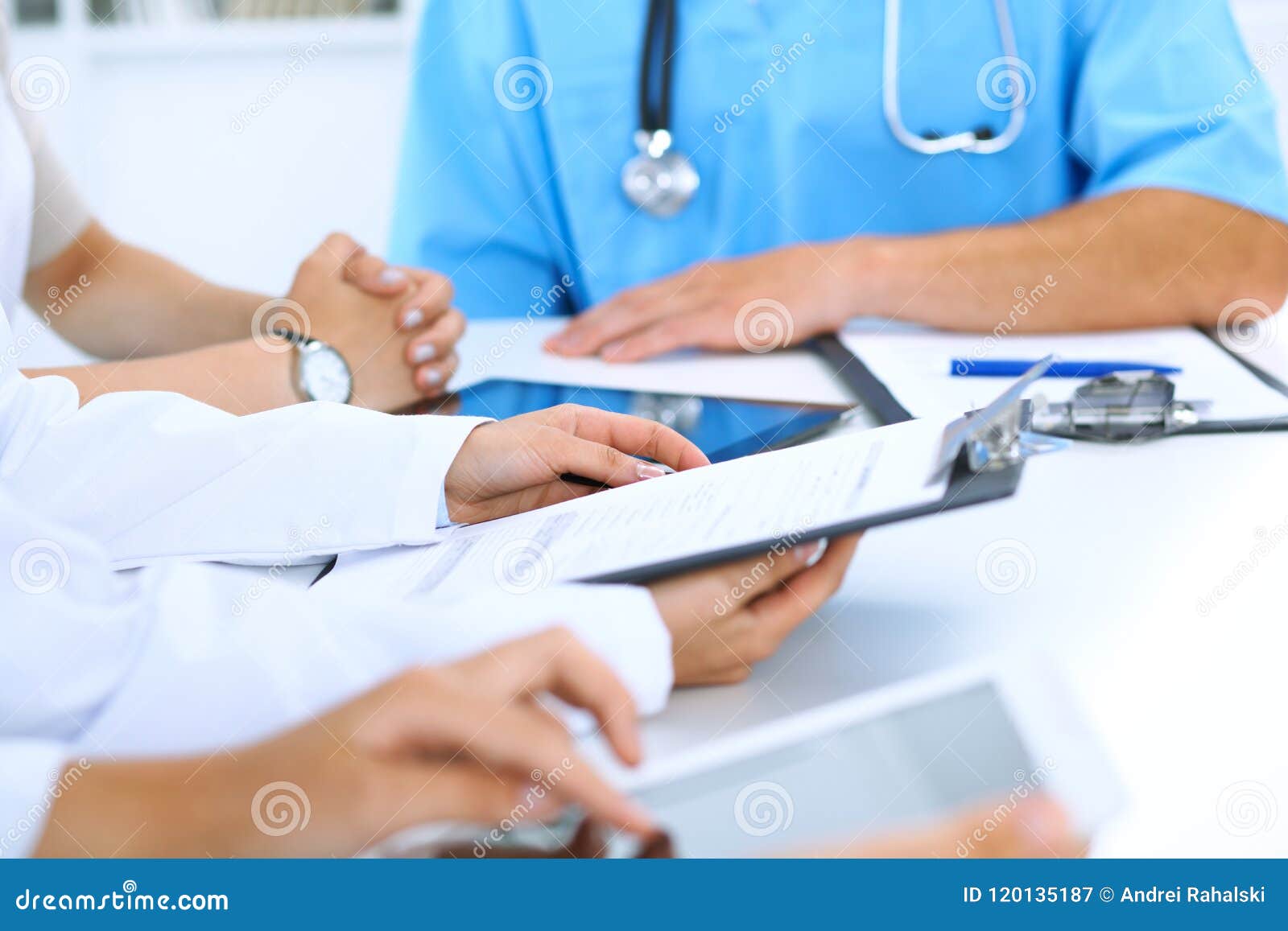 Doctor Using Tablet Computer at Medical Meeting, Closeup. Group of ...