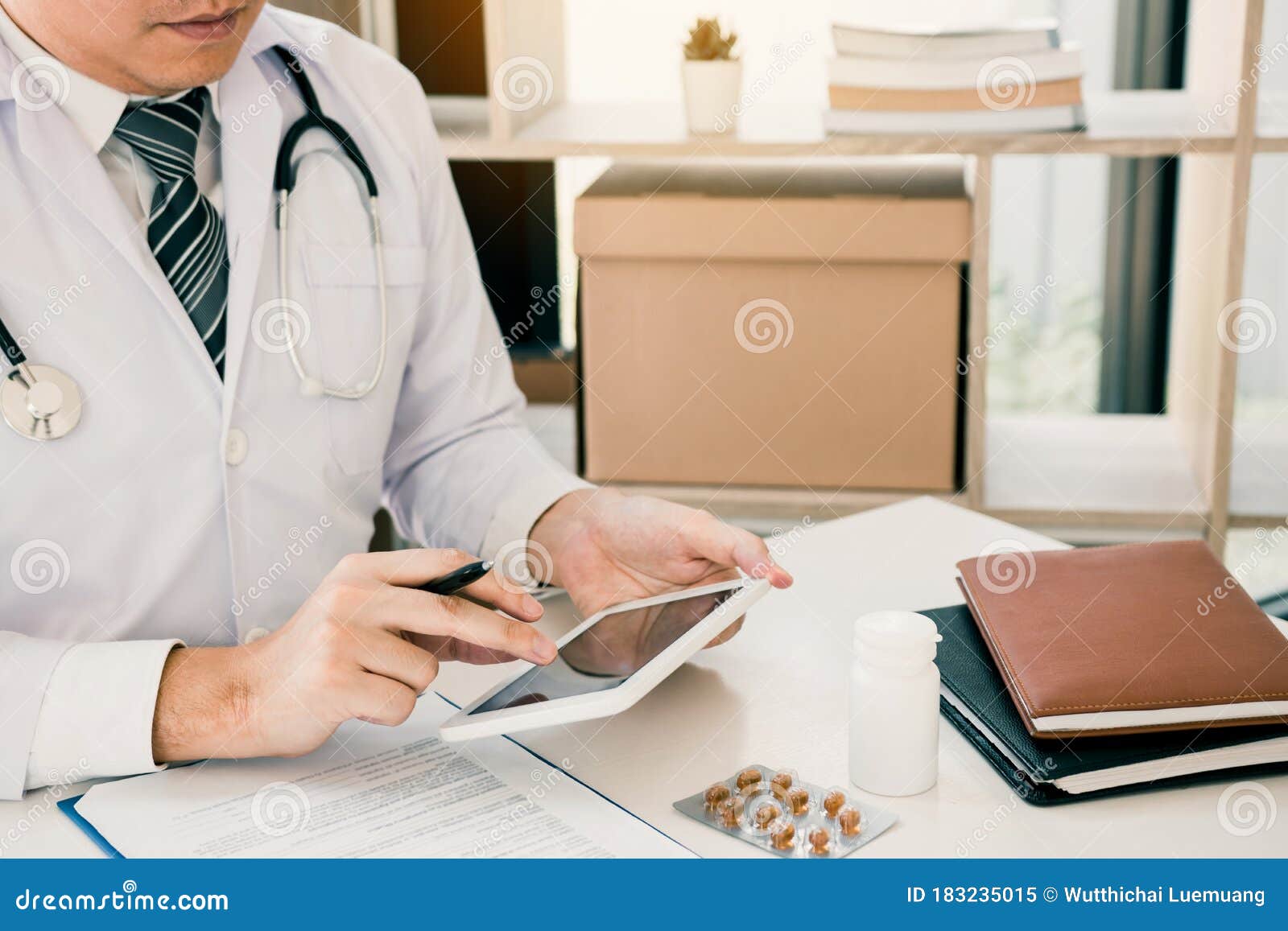 The Doctor is Using a Tablet To View the Patient`s Treatment Data and ...