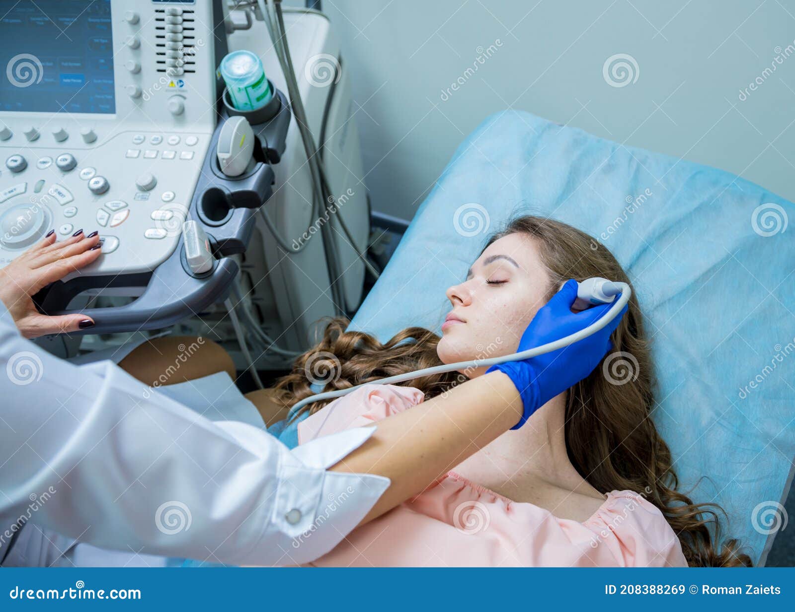 Doctor Using Ultrasound Scanning Machine For Examining A Head Of Woman