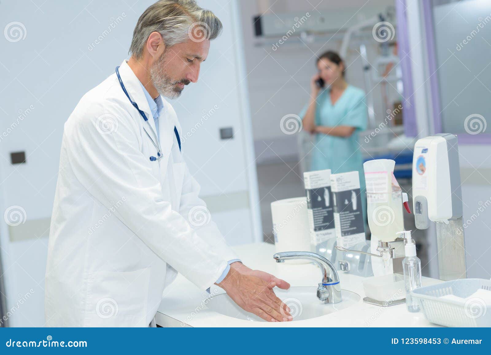 Doctor washing his hands stock image. Image of mature - 123598453