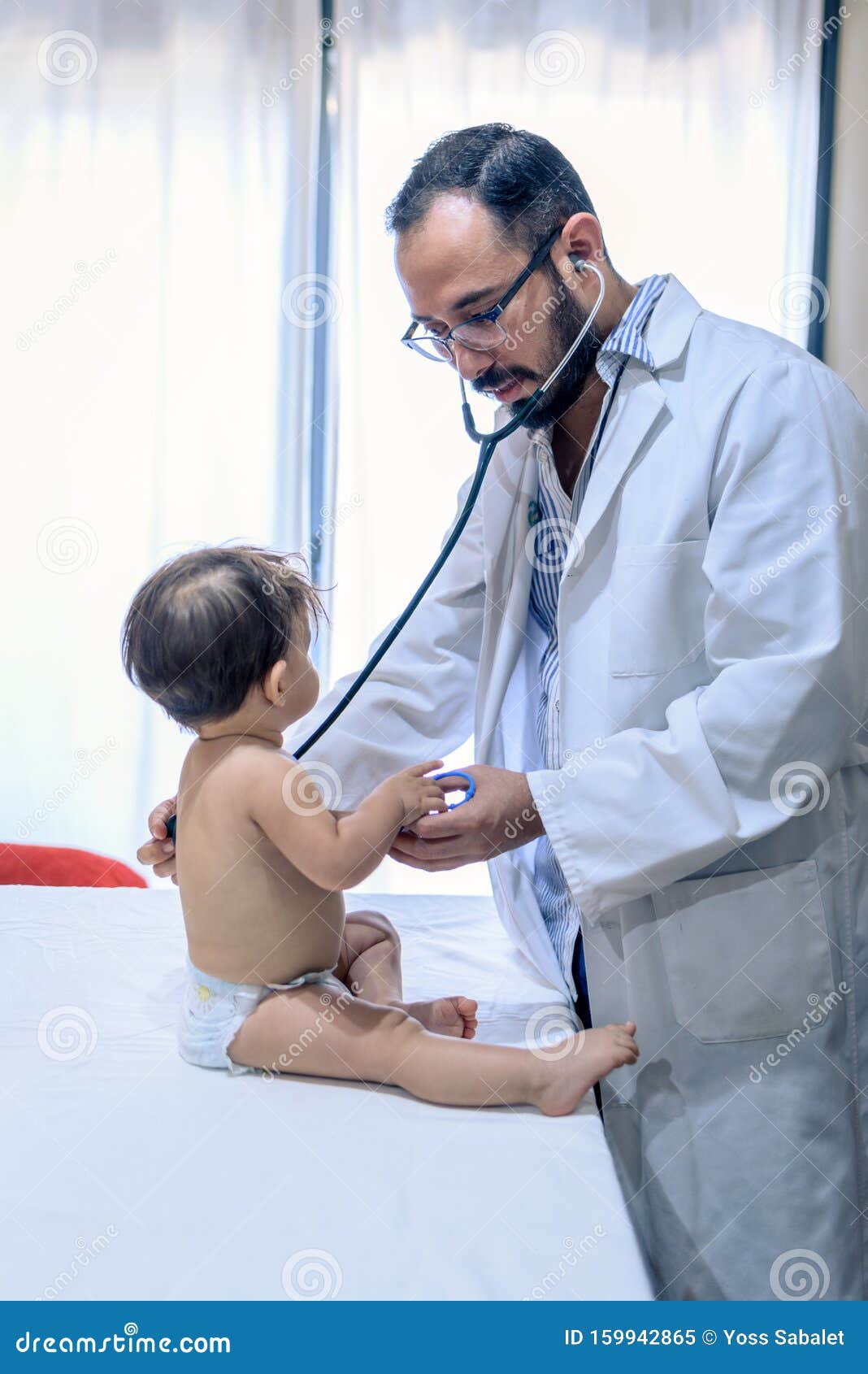 Doctor watching a baby stock image. Image of pediatrician - 159942865