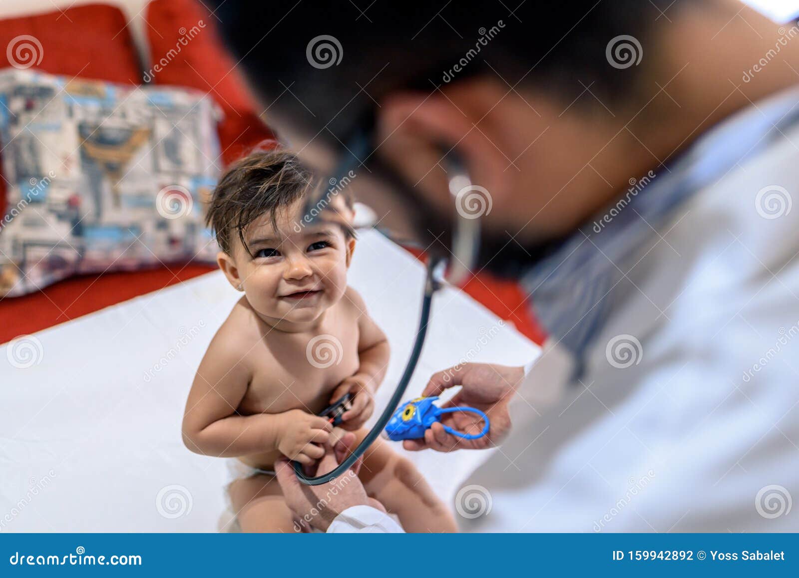 Doctor watching a baby stock photo. Image of pediatric - 159942892