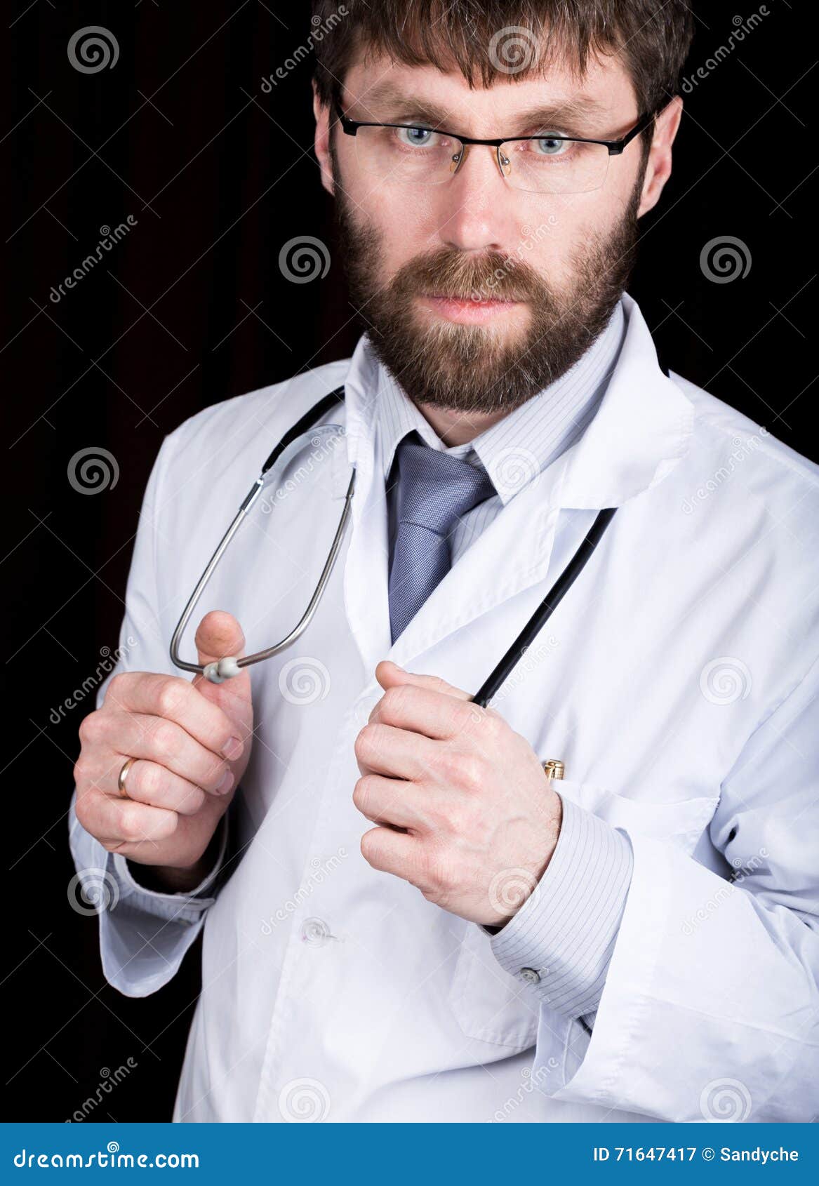 Doctor in a White Medical Robe, Standing and Holding a Stethoscope ...