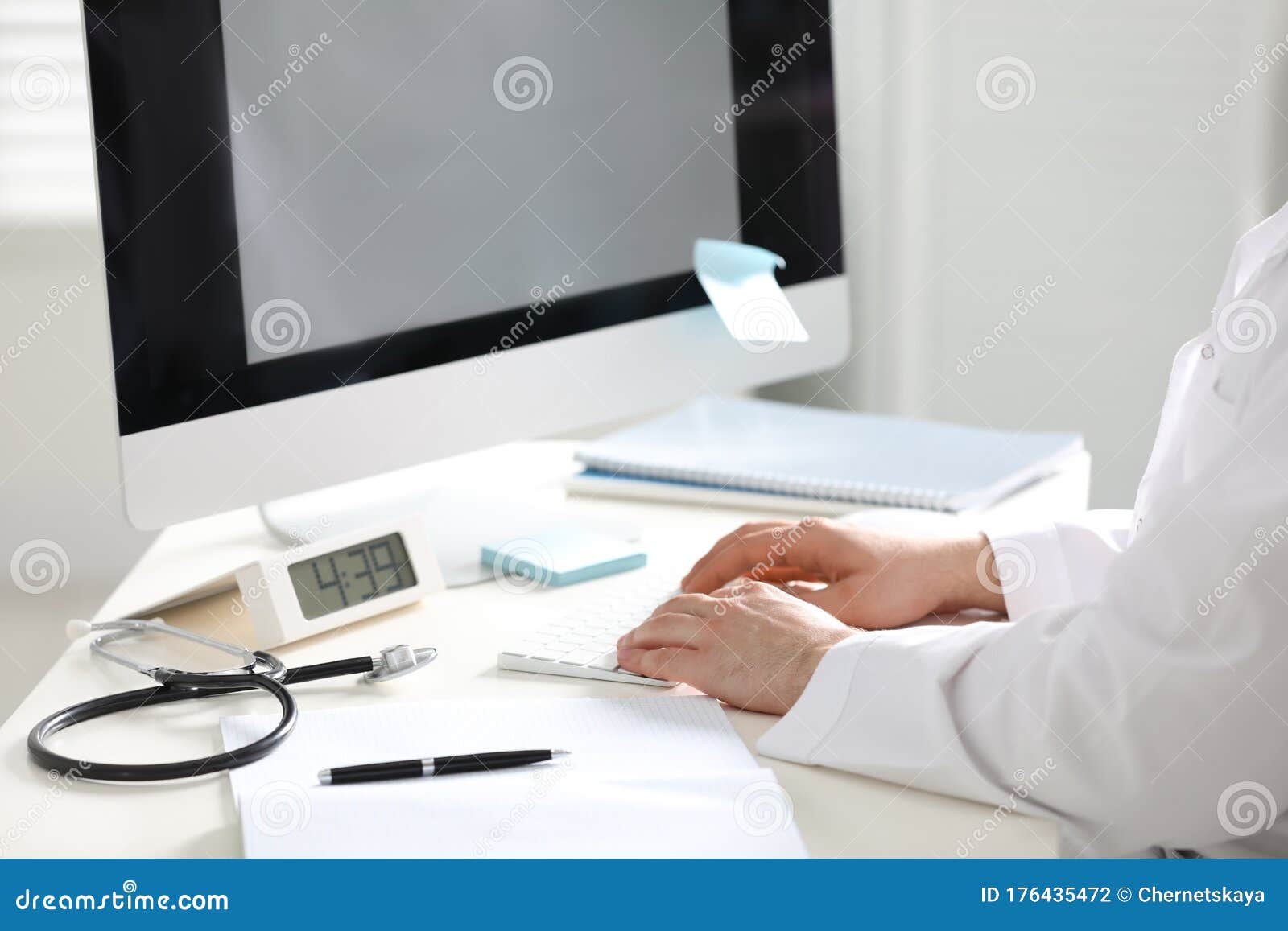 Doctor Working with Computer at Desk in Office Stock Photo - Image of ...