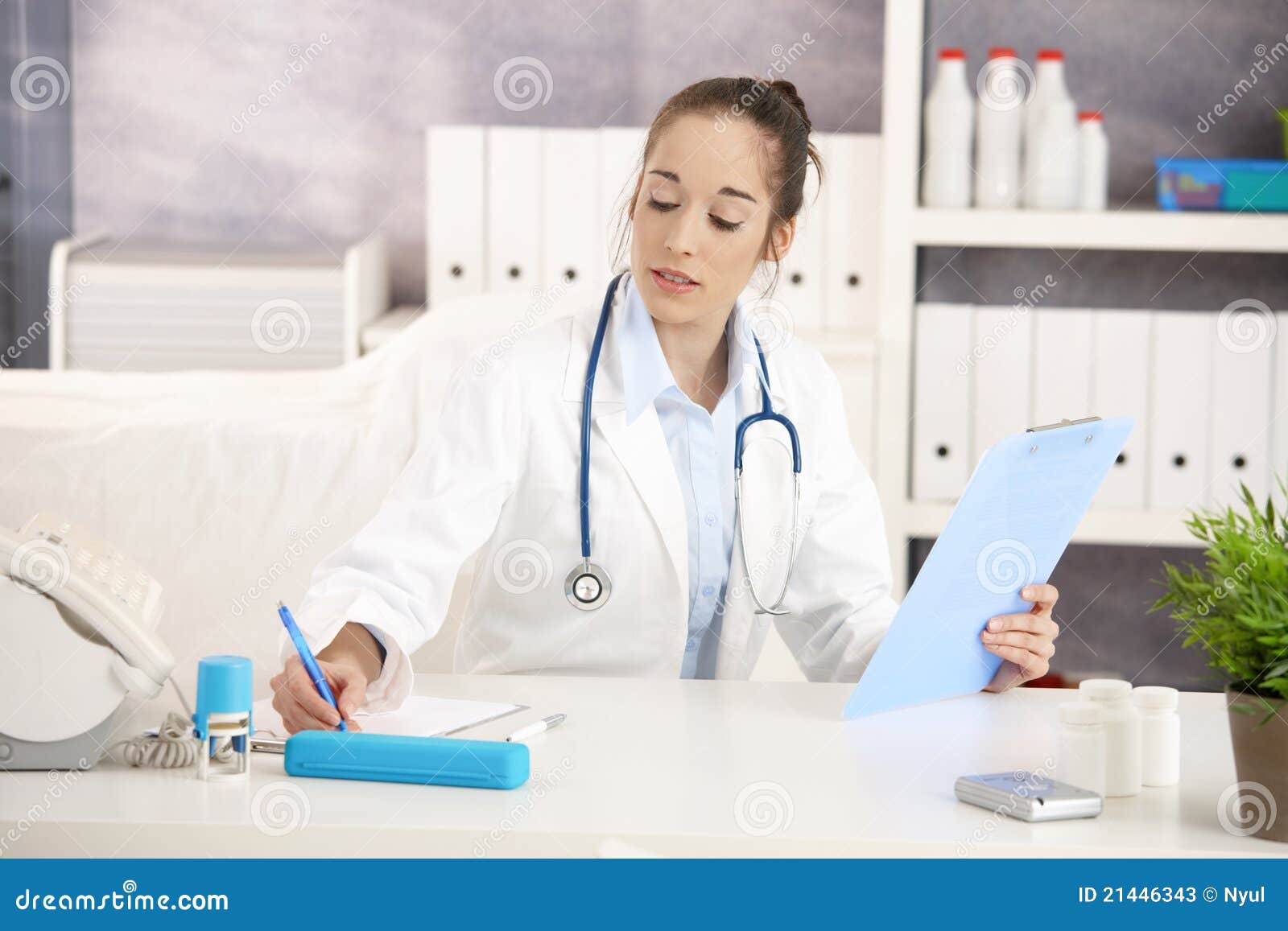 Doctor working at desk stock image. Image of concentrating - 21446343