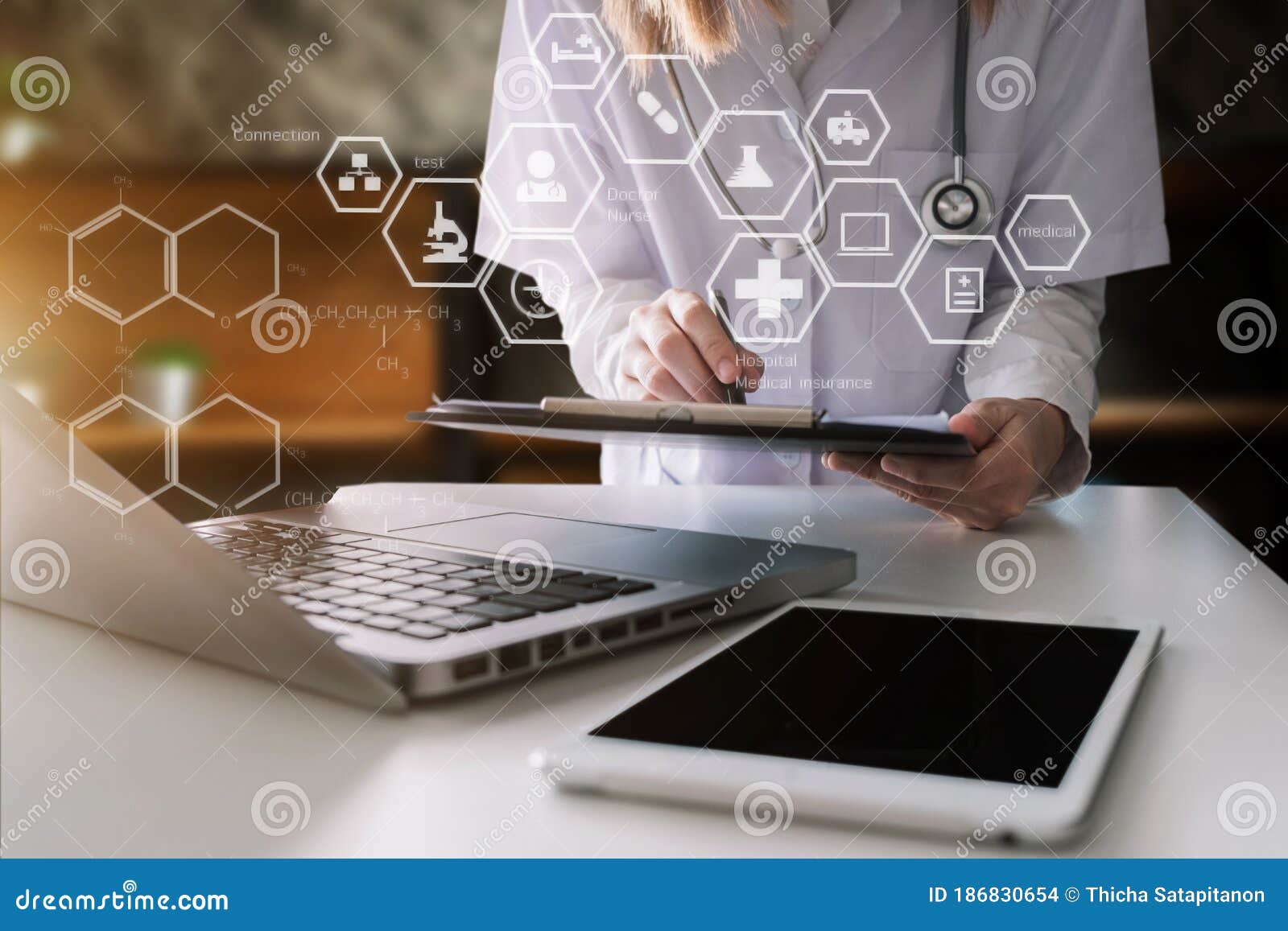Doctor Working on Desk with Laptop Computer and Paperwork in the Office ...