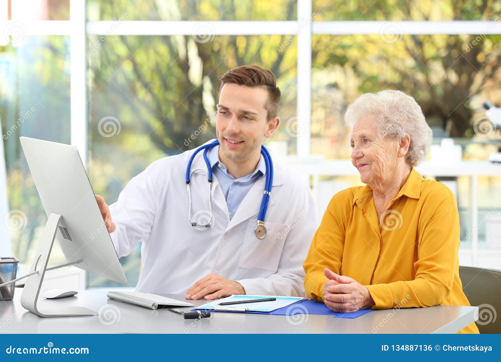 Doctor Working with Elderly Patient Stock Photo - Image of care ...