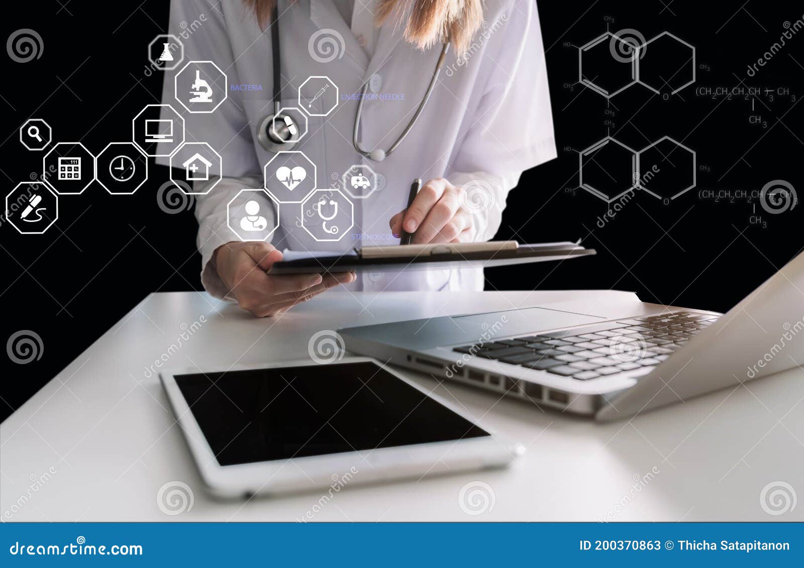 Doctor Working with Laptop Computer and Writing on Paperwork. Stock ...