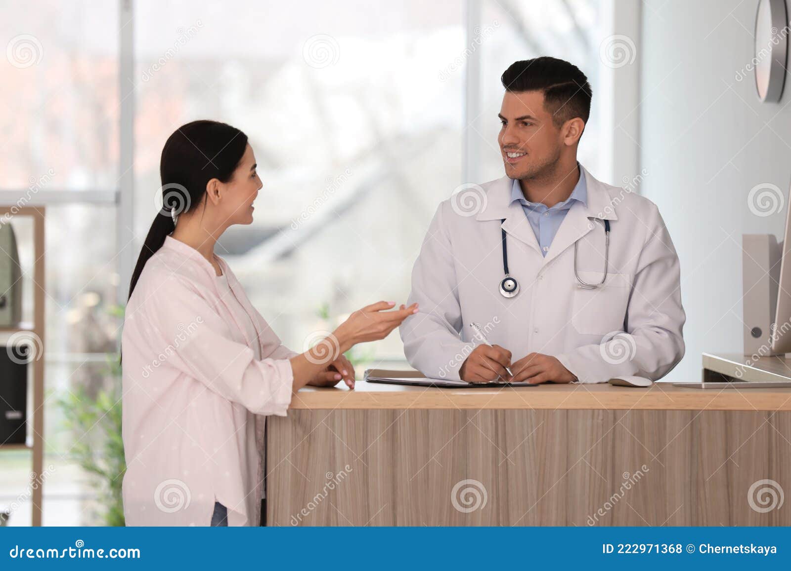 Doctor Working with Patient at Reception Stock Photo - Image of ...