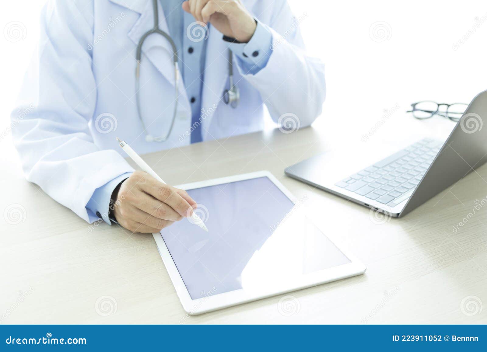 Doctor Working on Patient Database through Internet Laptop Computer ...