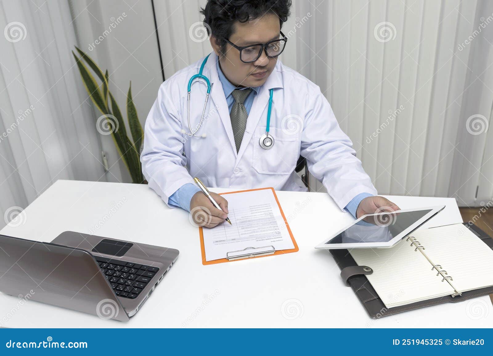 Doctor Working with Tablet Computer at Desk. Technology and Medical ...