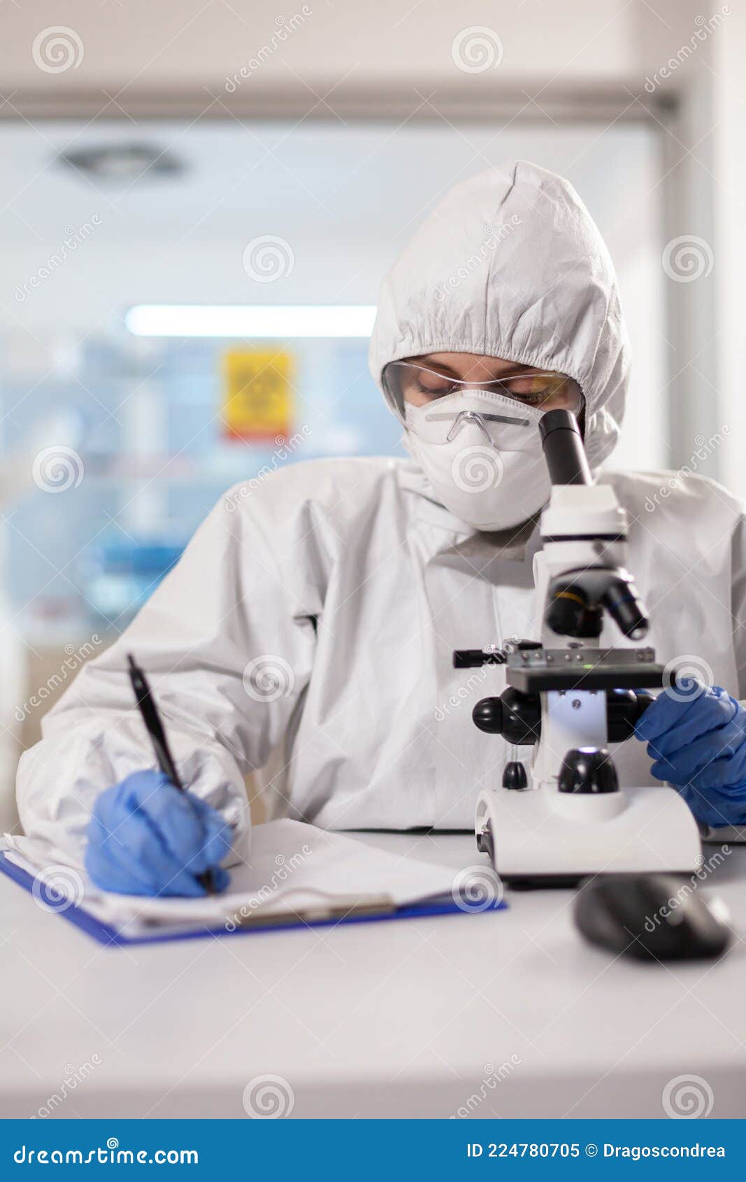 Doctor Writing Notes Dressed in Ppe Suit and Visor Mask Stock Image ...