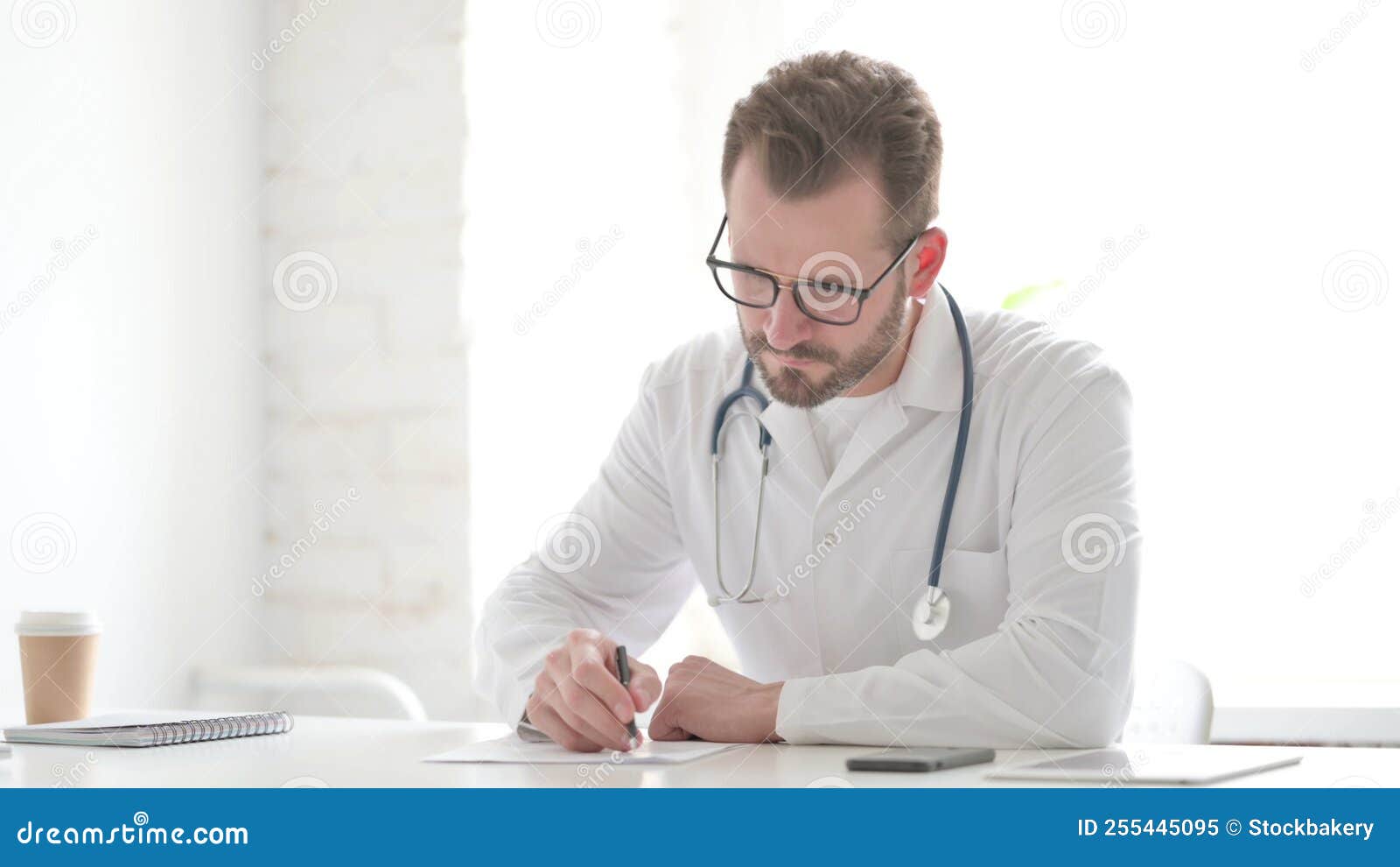 Doctor Writing on Paper in Clinic Stock Image - Image of contemplation ...