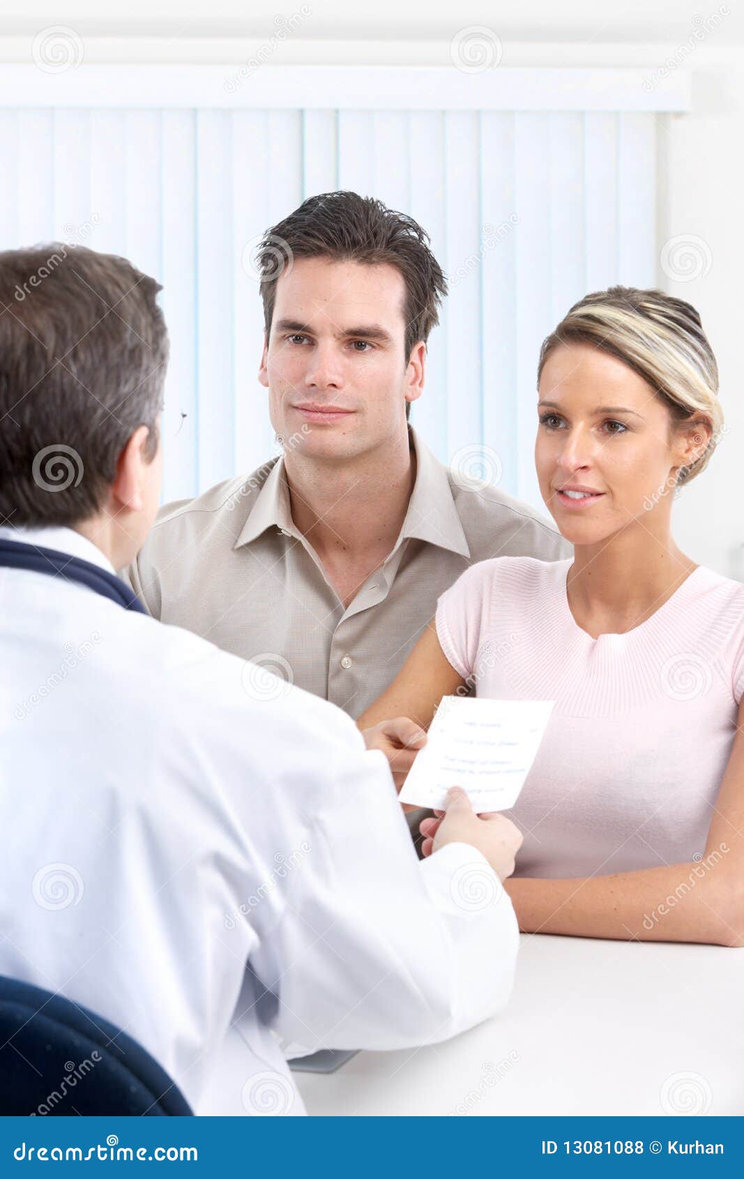 Doctor and young couple stock photo. Image of care, medicine - 13081088
