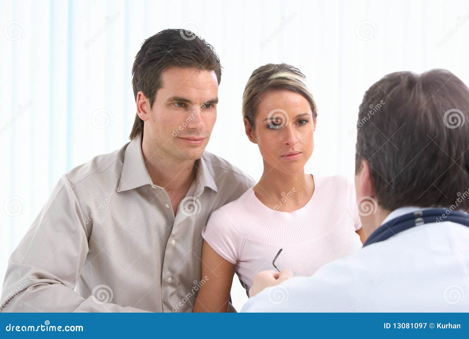 Doctor and young couple stock image. Image of doctor - 13081097