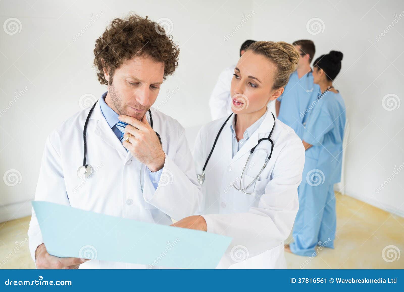Doctors Analyzing File in Hospital Stock Image - Image of doctor ...