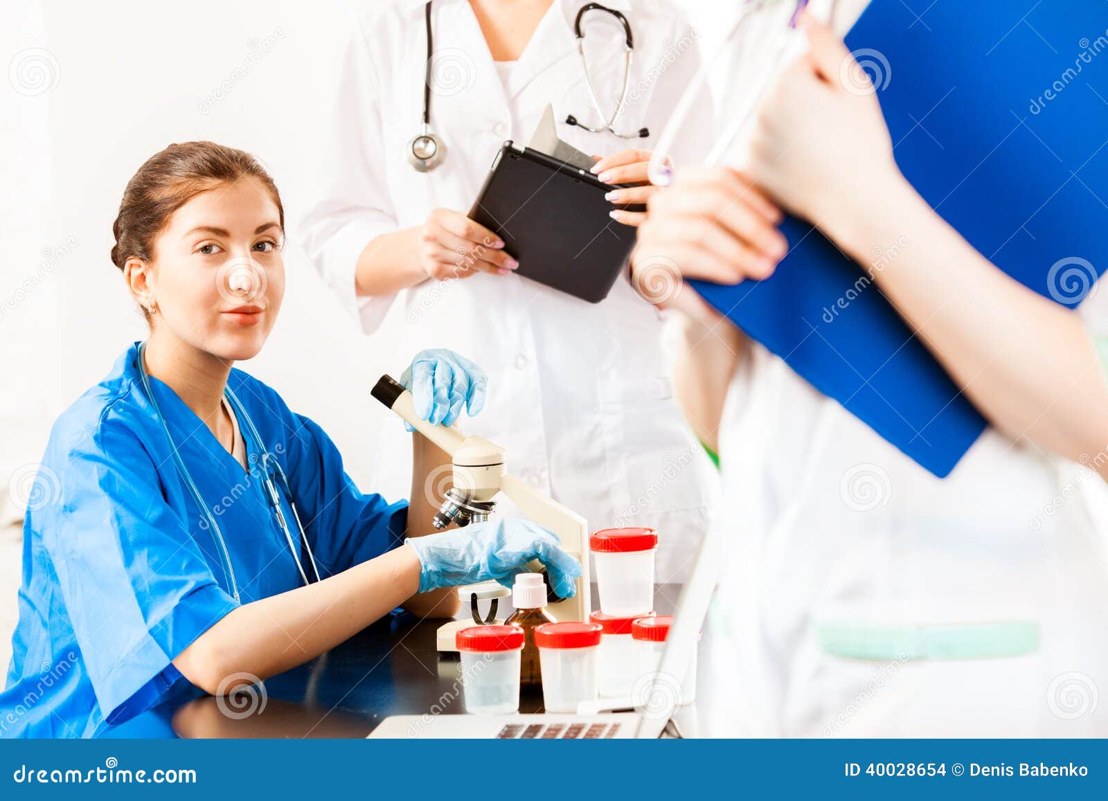 Doctors Assistant Working with Microscope Stock Photo - Image of ...