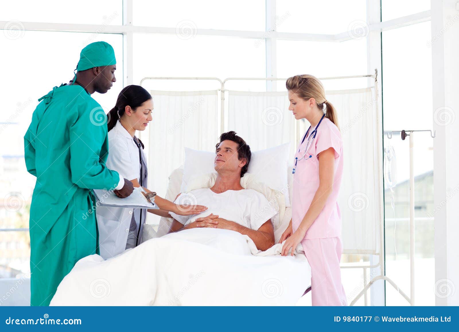 Doctors Caring for a Patient Stock Image - Image of patient, cheerful ...
