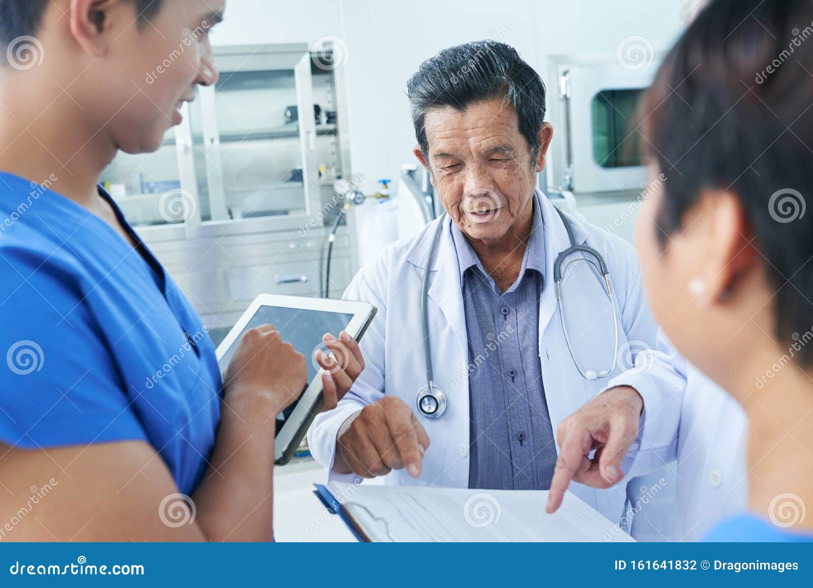 Doctors Checking Medical History of Patient Stock Photo - Image of care ...