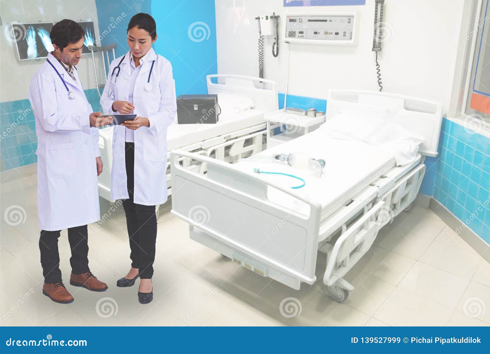 Doctors Checking Patient Information on a Tablet Device Stock Image ...
