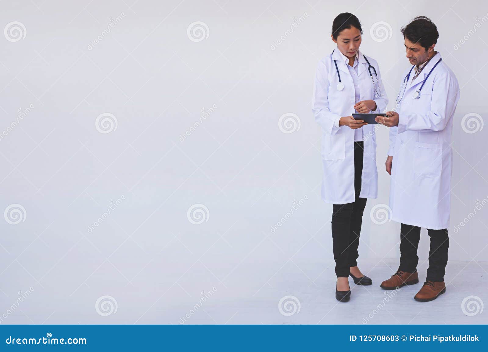 Doctors Checking Patient Information on a Tablet Device Stock Image ...