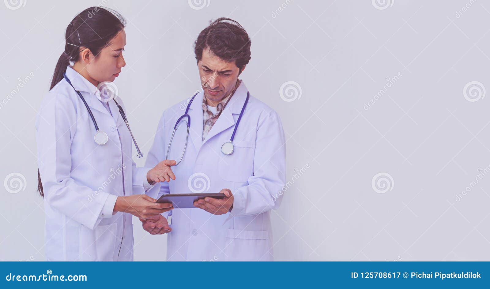 Doctors Checking Patient Information on a Tablet Device Stock Image ...