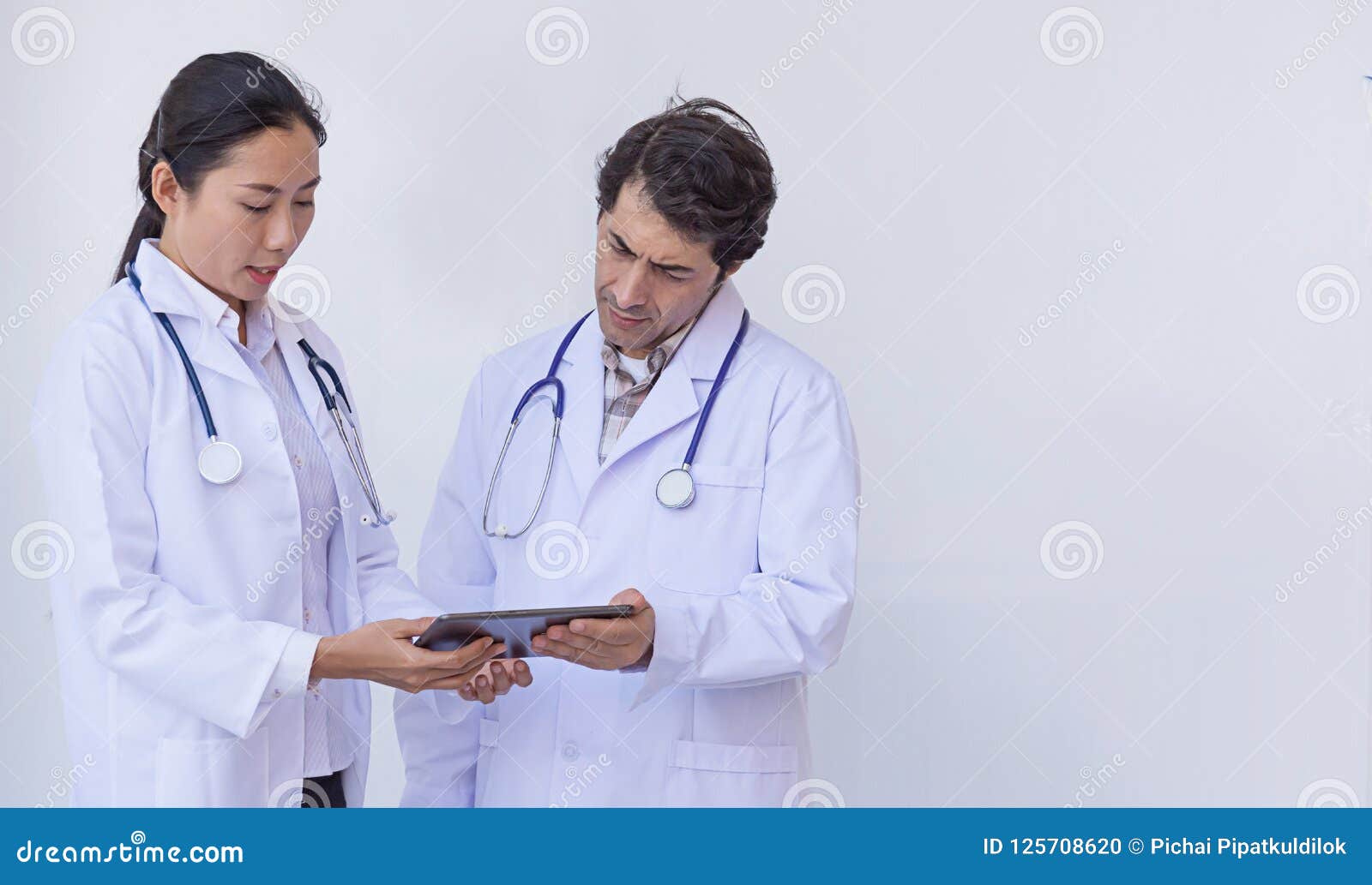 Doctors Checking Patient Information on a Tablet Device Stock Photo ...