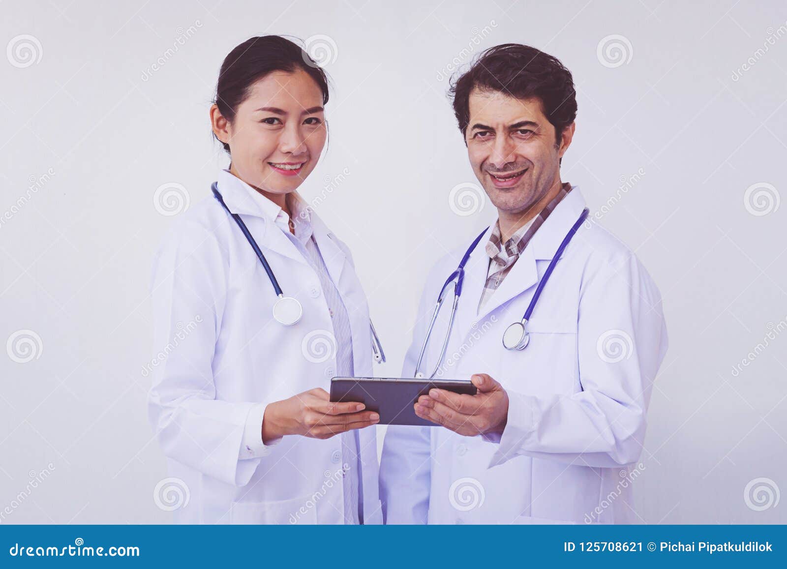 Doctors Checking Patient Information on a Tablet Device Stock Image ...