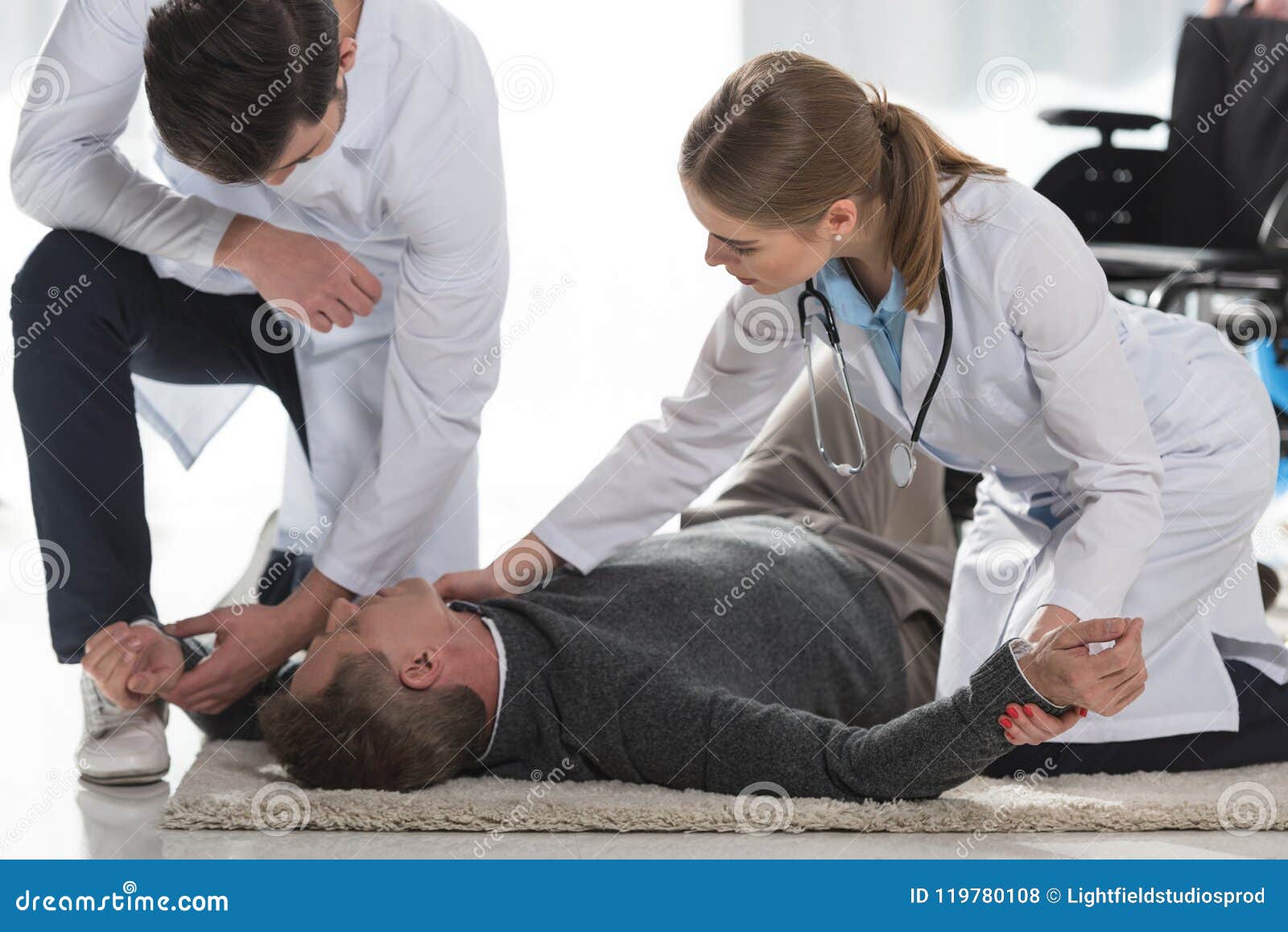 Doctors checking pulse of stock photo. Image of middle - 119780108