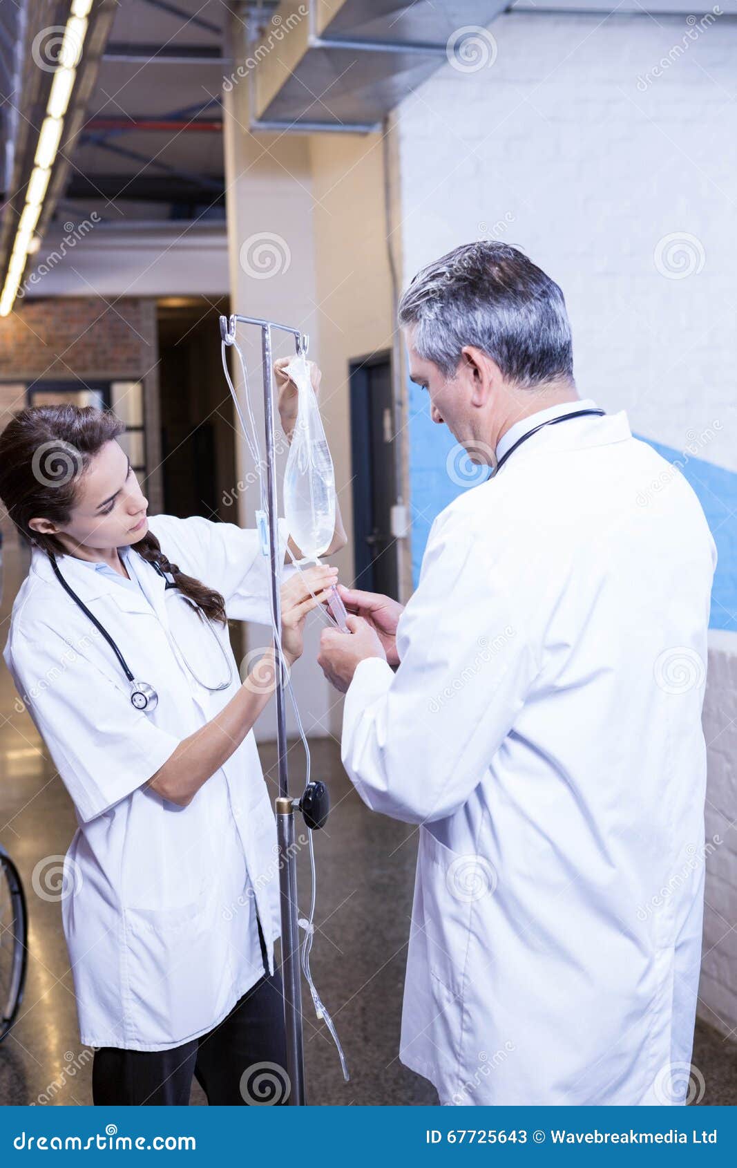 Doctors Checking a Saline Drip Stock Image - Image of hospital, medical ...