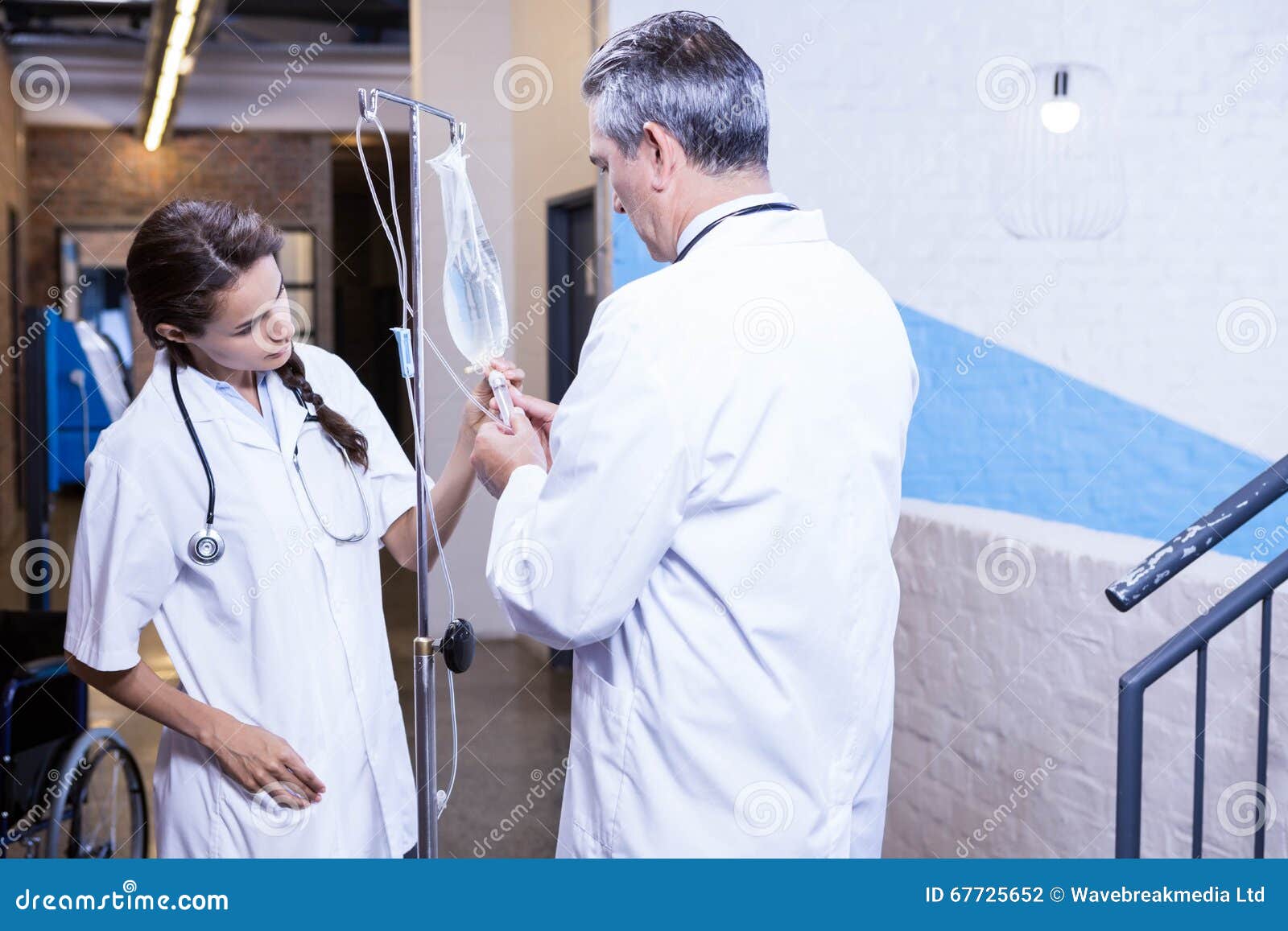 Doctors Checking a Saline Drip Stock Photo - Image of mature ...