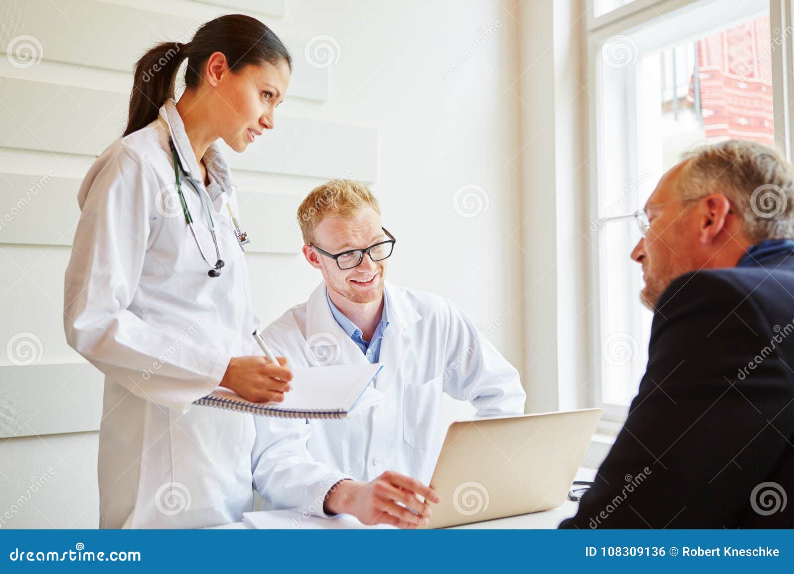 Doctors in Consultation with Patient Stock Photo - Image of internet ...