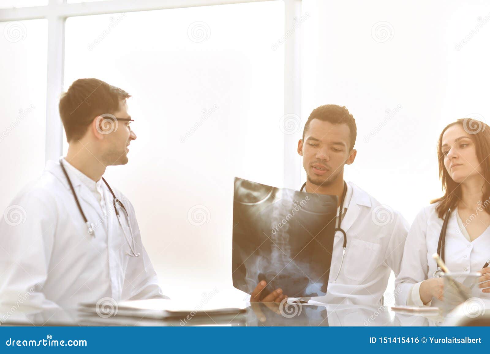 Doctors Discuss the X-ray of the Patient Sitting at the Table Stock ...