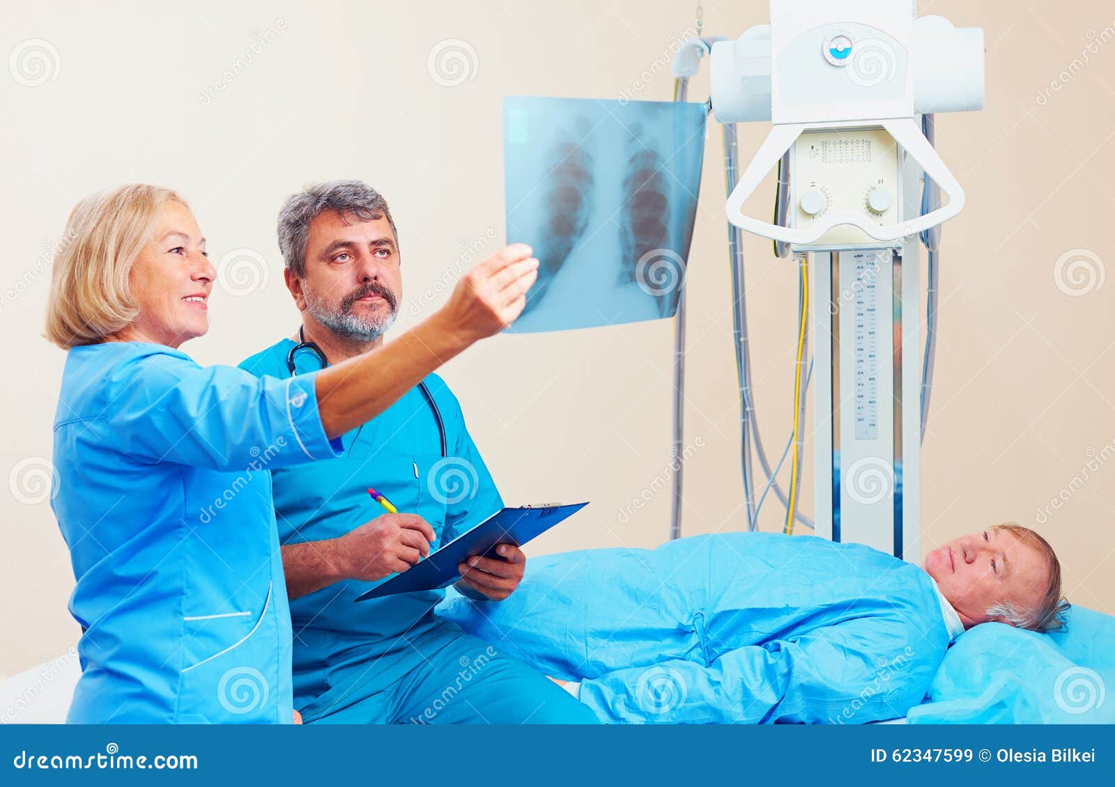 Doctors Discussing the Roentgen Radiogram in X-ray Room with Patient ...