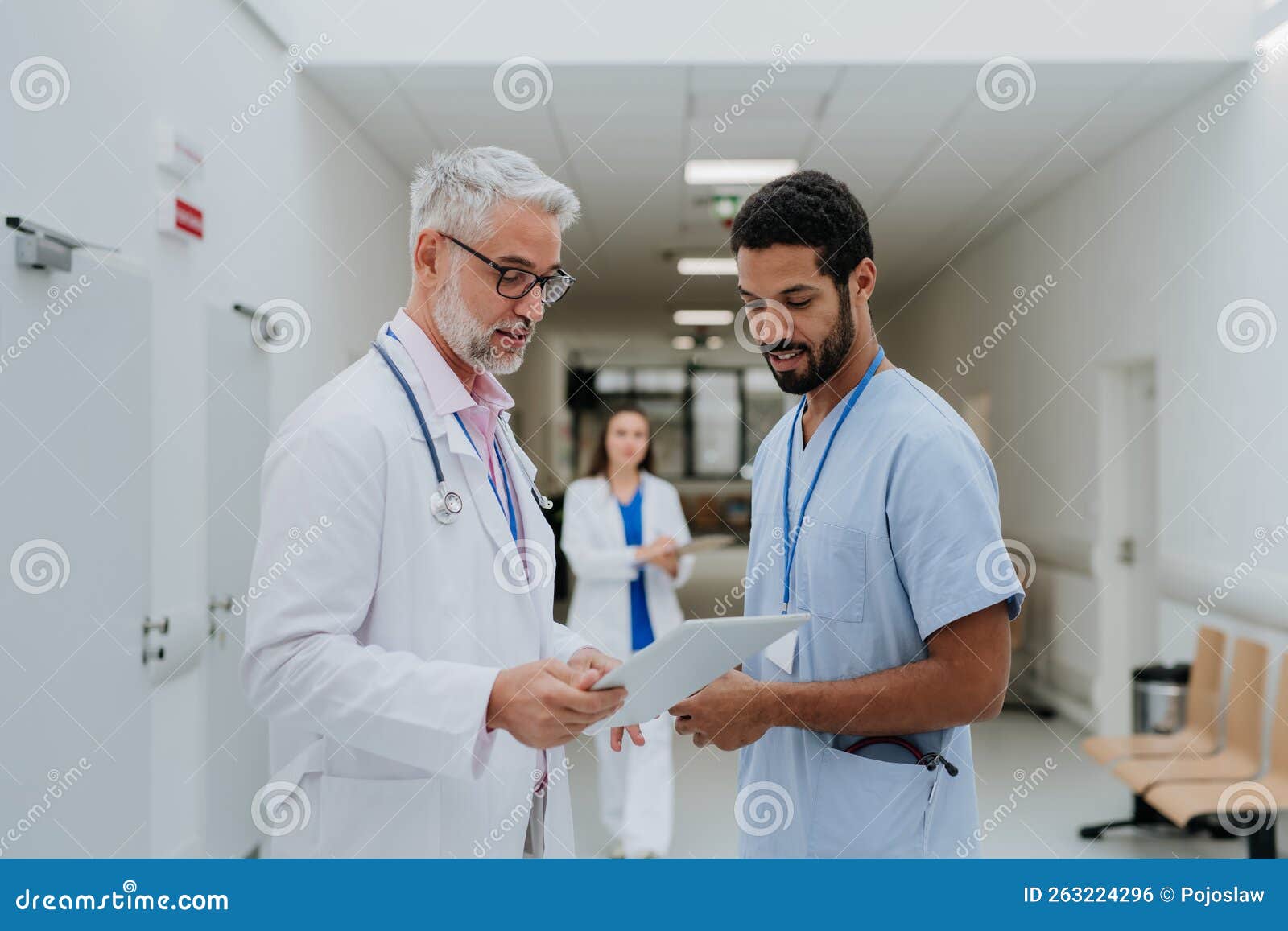Doctors Discussing Something at Hospital Corridor. Stock Photo - Image ...