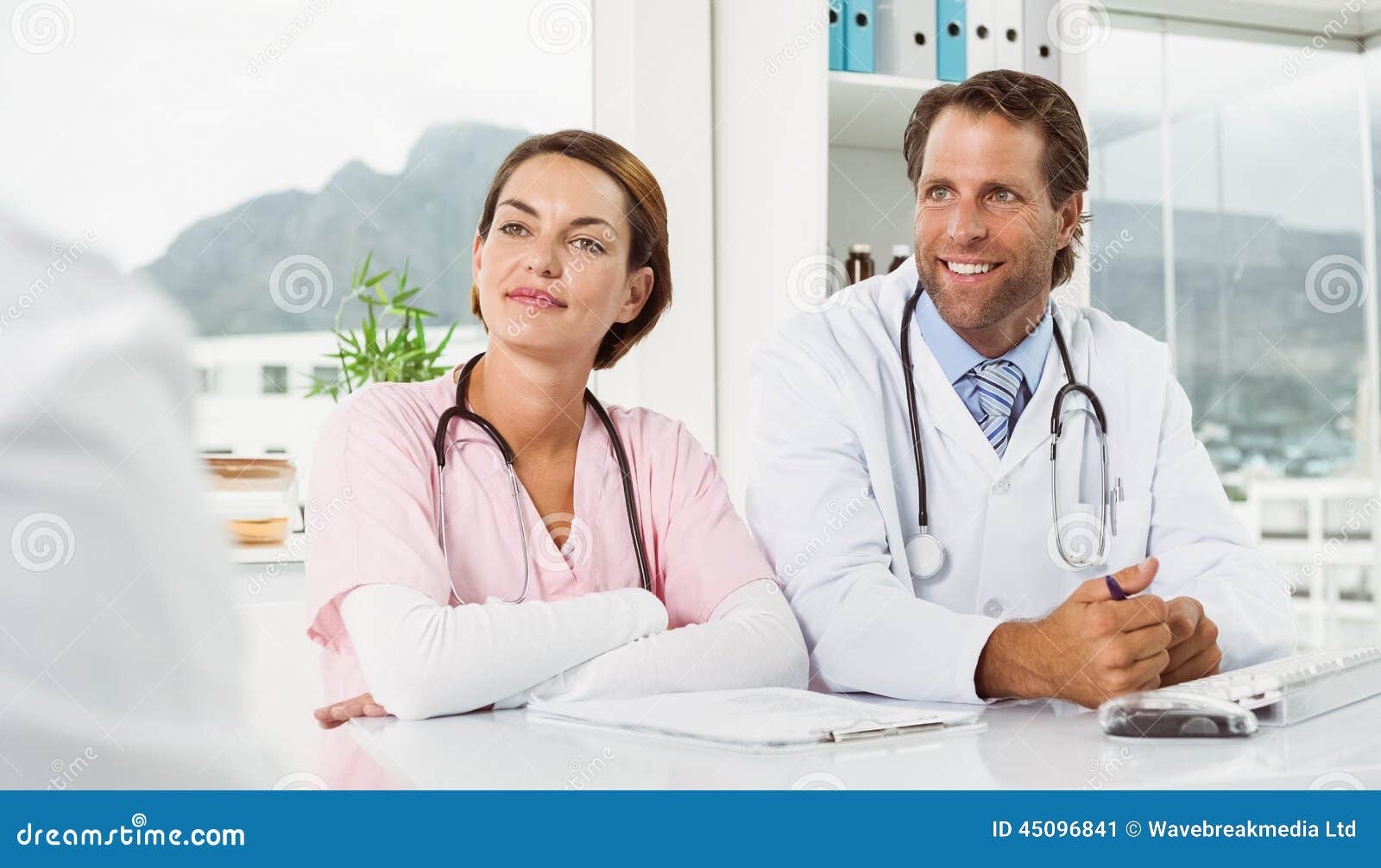 Doctors in Discussion with Patient in Medical Office Stock Image ...