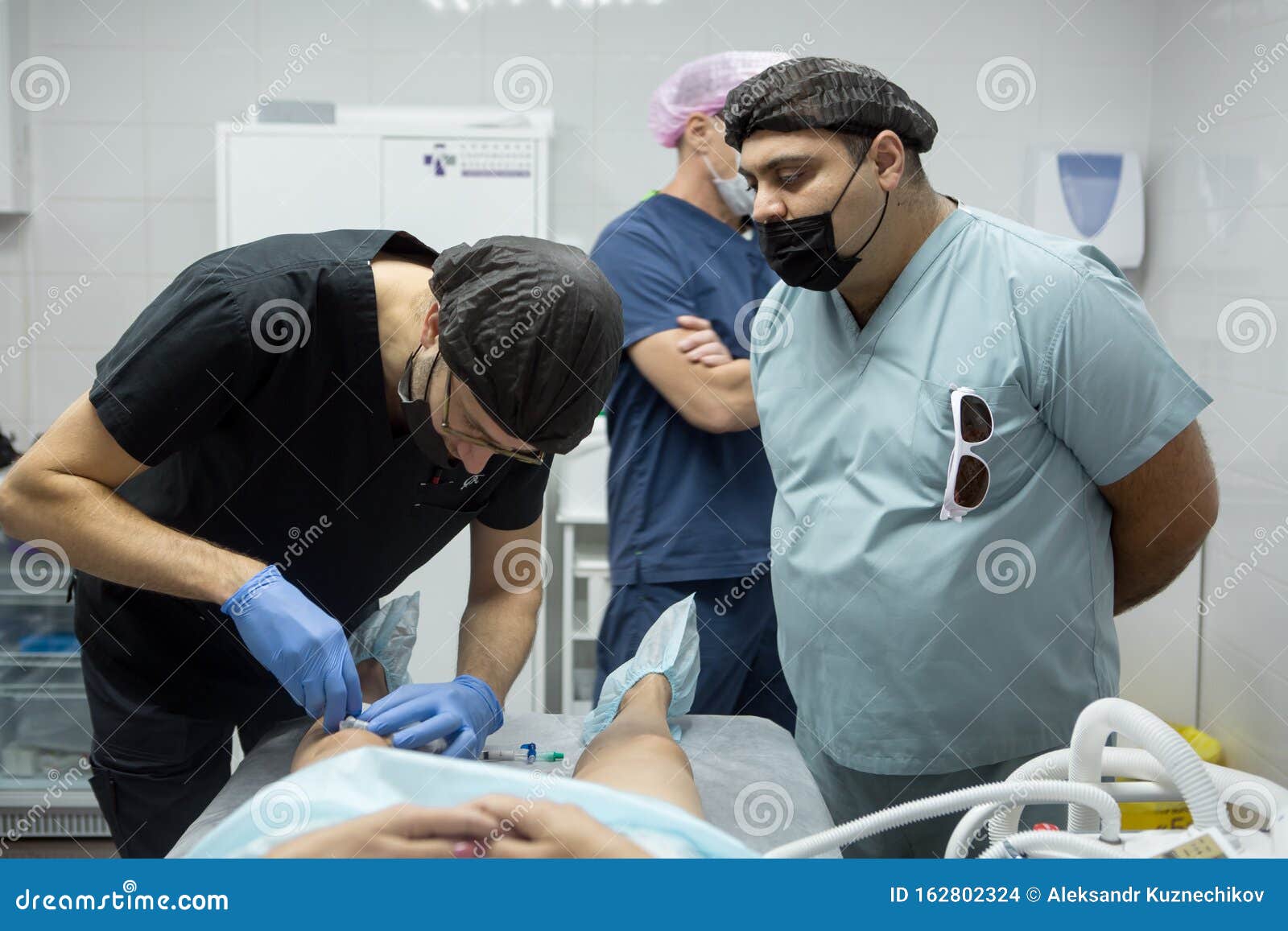 Doctors Doing Vein Surgery Procedure Stock Photo - Image of clinic ...