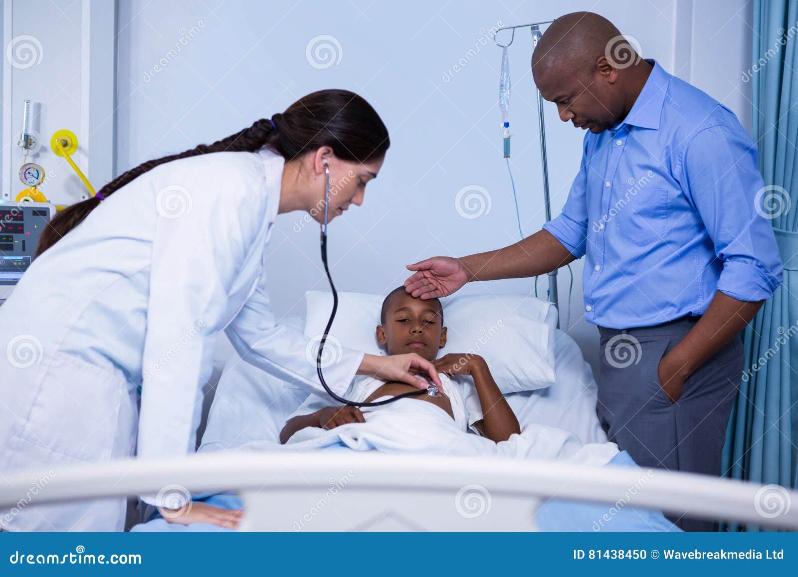 Doctors Examining Patient in Ward Stock Photo - Image of examining ...