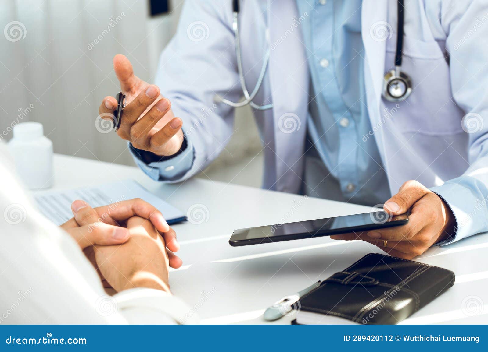 Doctors are Explaining the Treatment of a Sick Patient in Tablets while ...