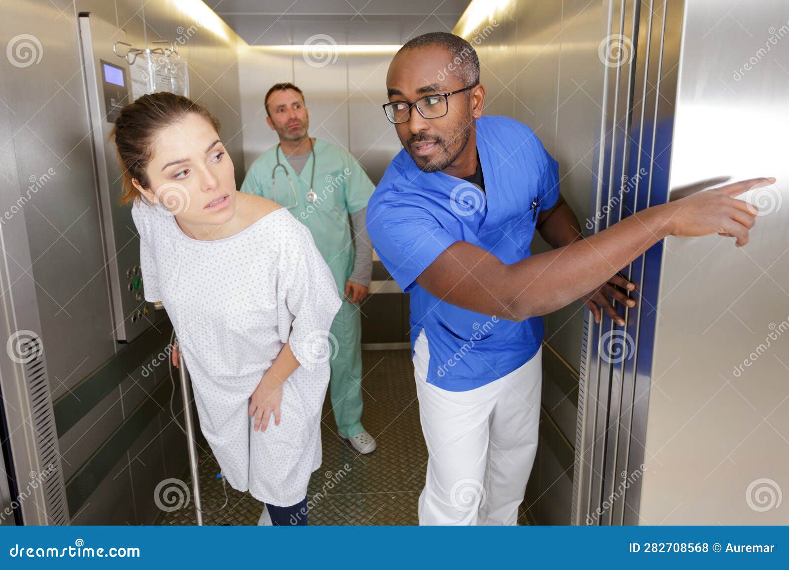 Doctors and Female Patient Walking Out Elevator Stock Photo - Image of ...