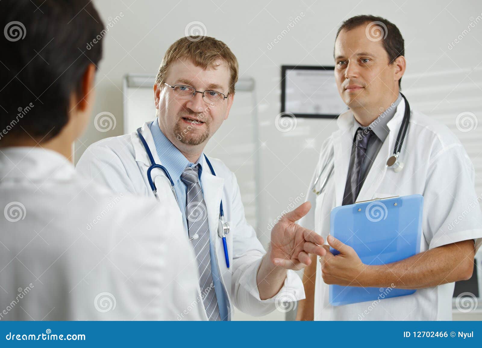 Doctors Having Consultation Stock Photo - Image of consultant, coat ...